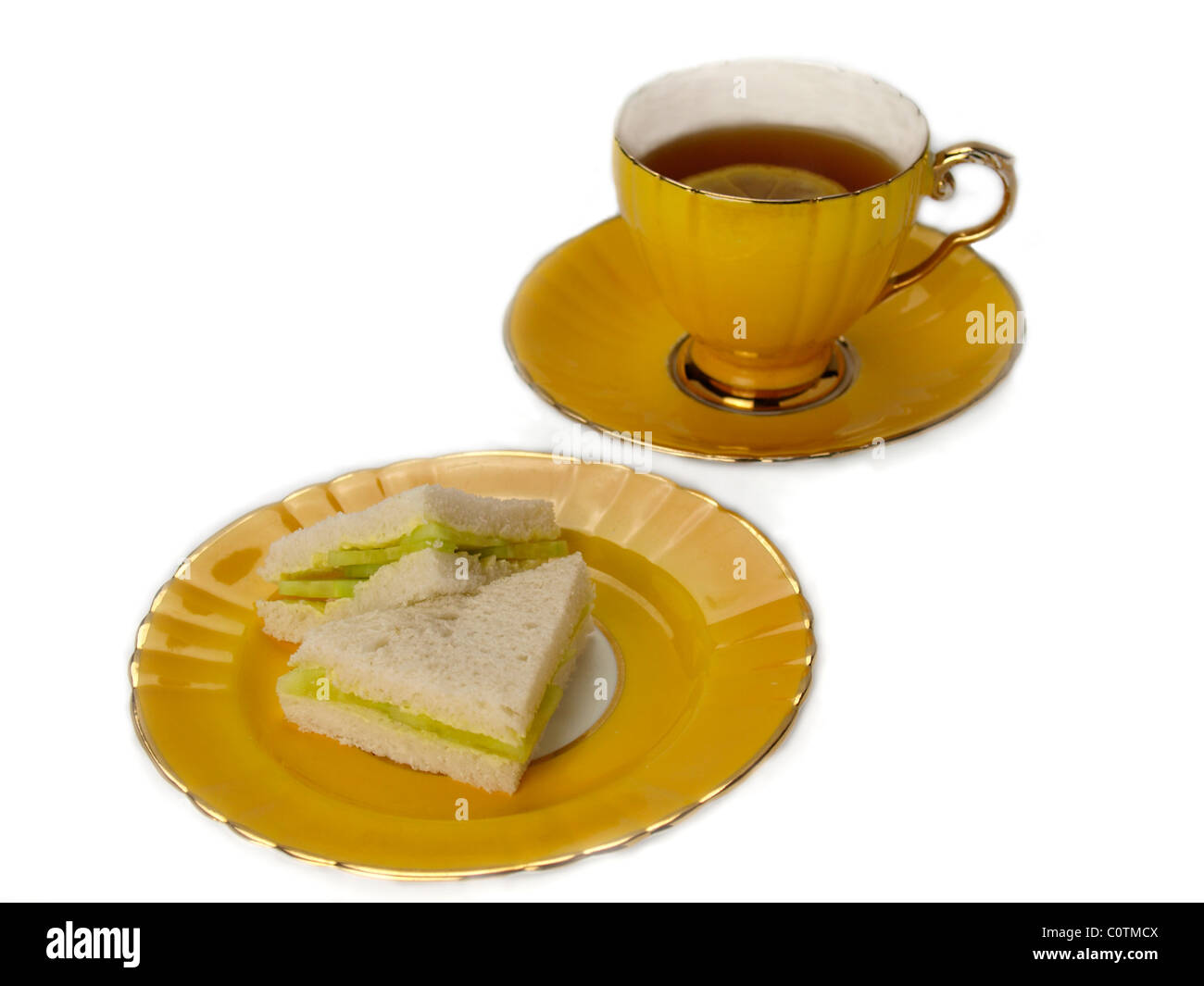 Yellow Cup, saucer and plate Stock Photo - Alamy