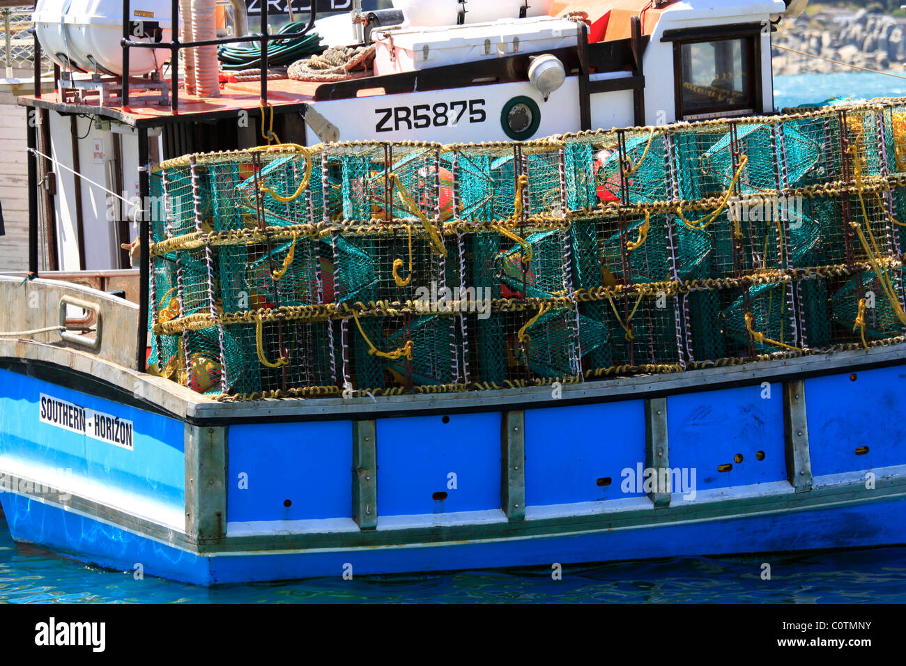 Crayfish pots stacked on fishing boat in Hout Bay Harbour near Cape ...