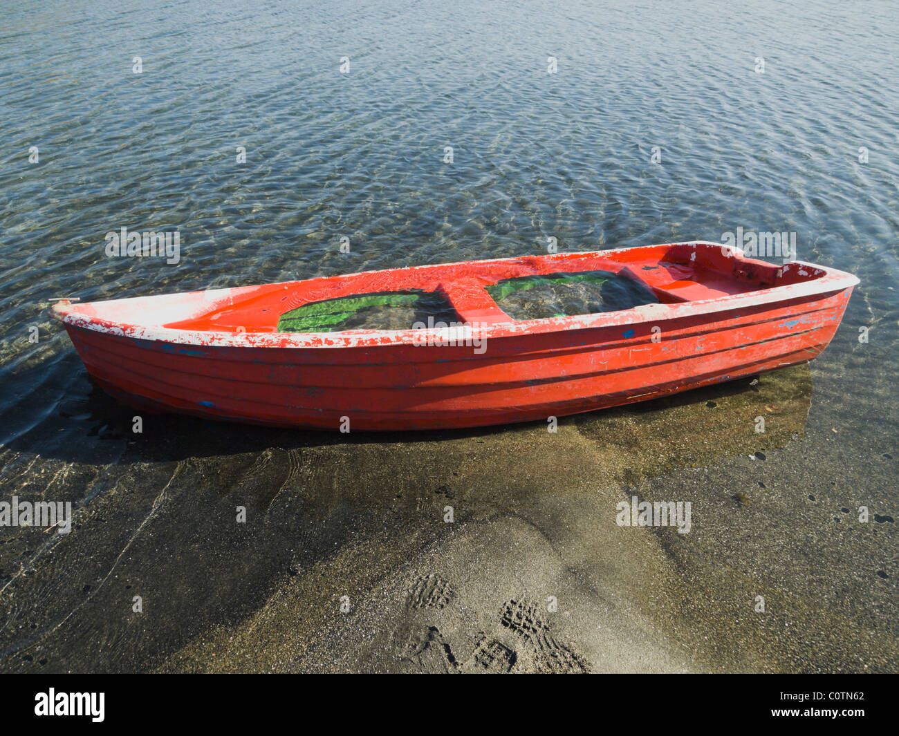 Damaged boat on lake shore Stock Photo - Alamy