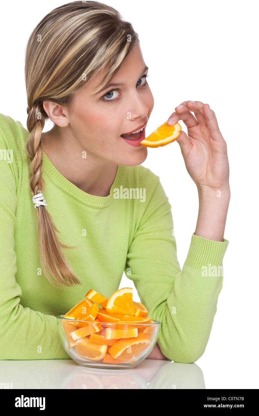 Woman biting slice of orange on white background Stock Photo - Alamy