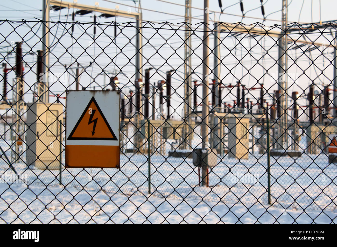 winter scene with warning signs on high voltage substation Stock Photo ...
