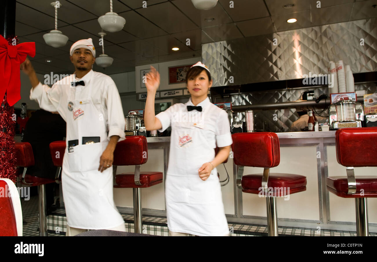 Waiters dance in a famous dinner restaurant on South street in ...