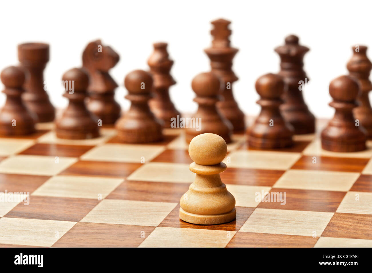 One pawn against all - wooden chess pieces on chessboard. Selective ...