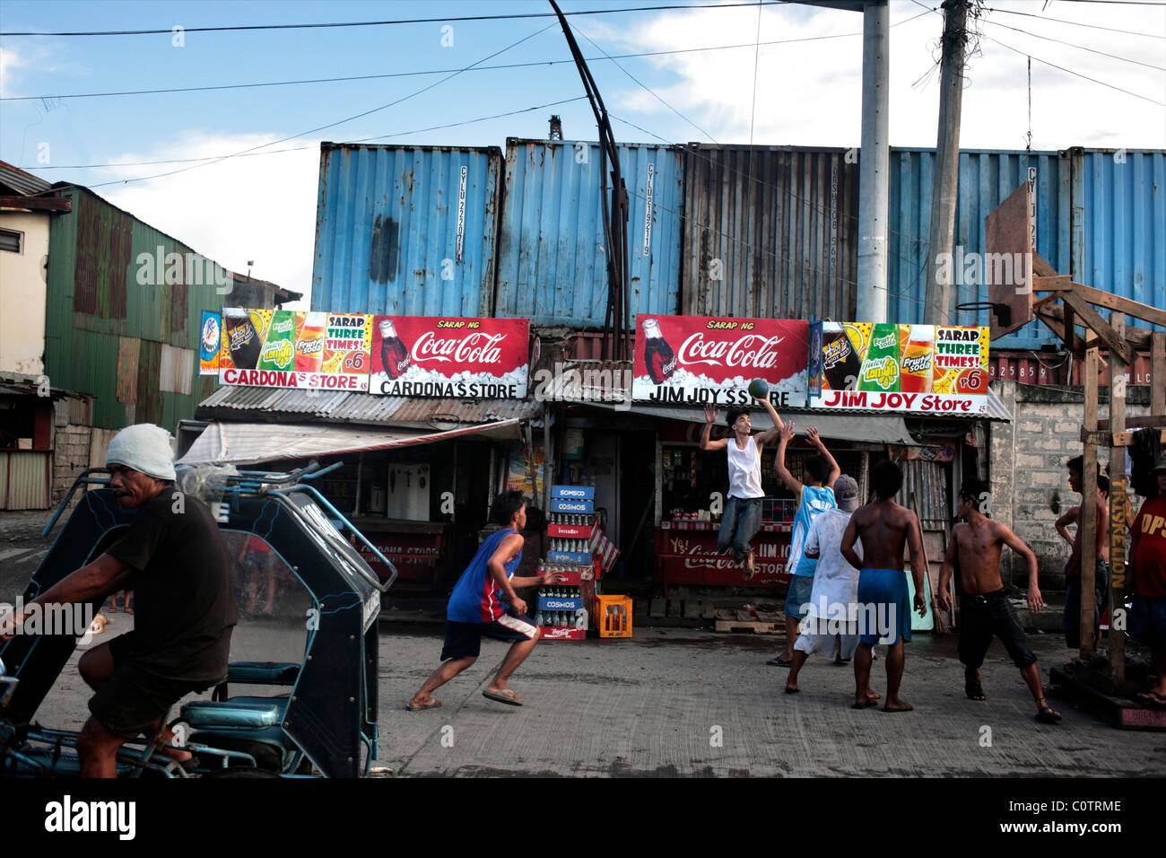 Youths play basketball in a small area in the Parola district of Tondo ...