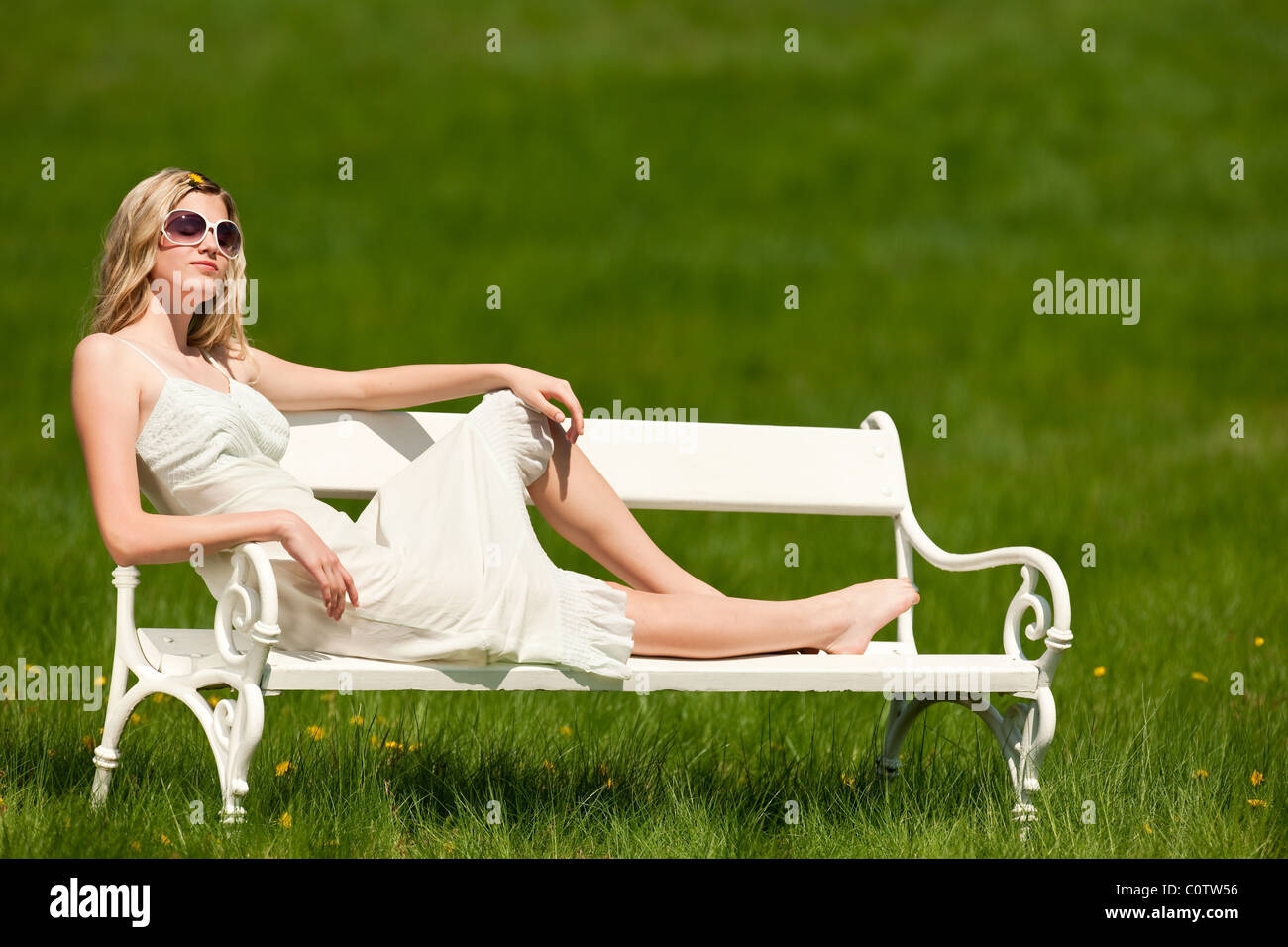 Woman sunbathing on bench hi-res stock photography and images - Alamy