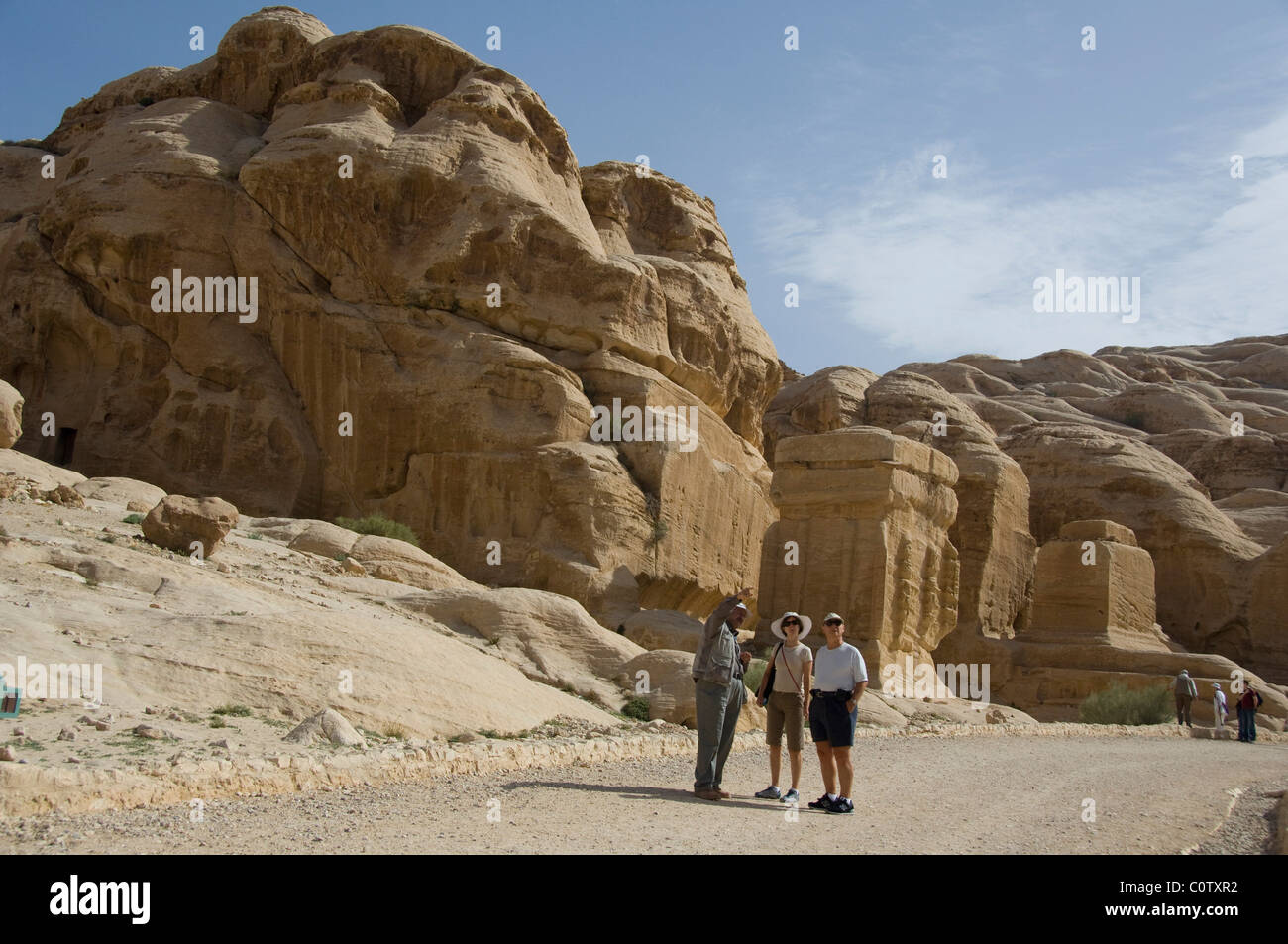 Jordan, Ancient Nabataean city of Petra. Tourists with guide in front ...