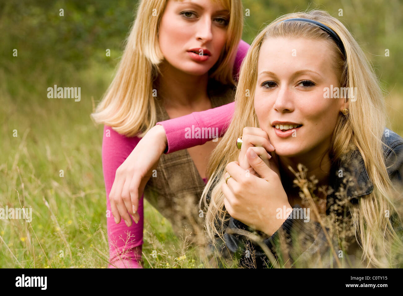 two sisters in a park having fun Stock Photo - Alamy