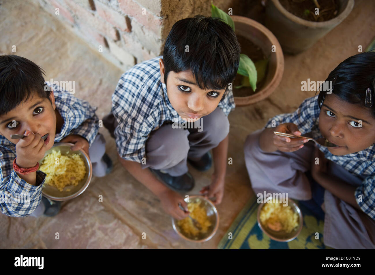 Three school children taking their lunch Stock Photo - Alamy