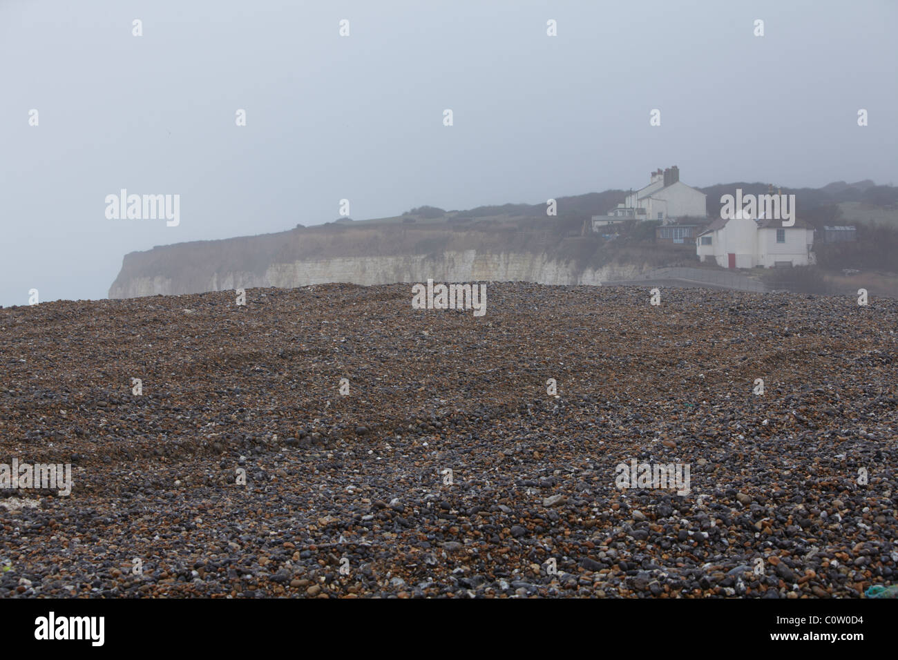 misty beach and cliff Stock Photo - Alamy