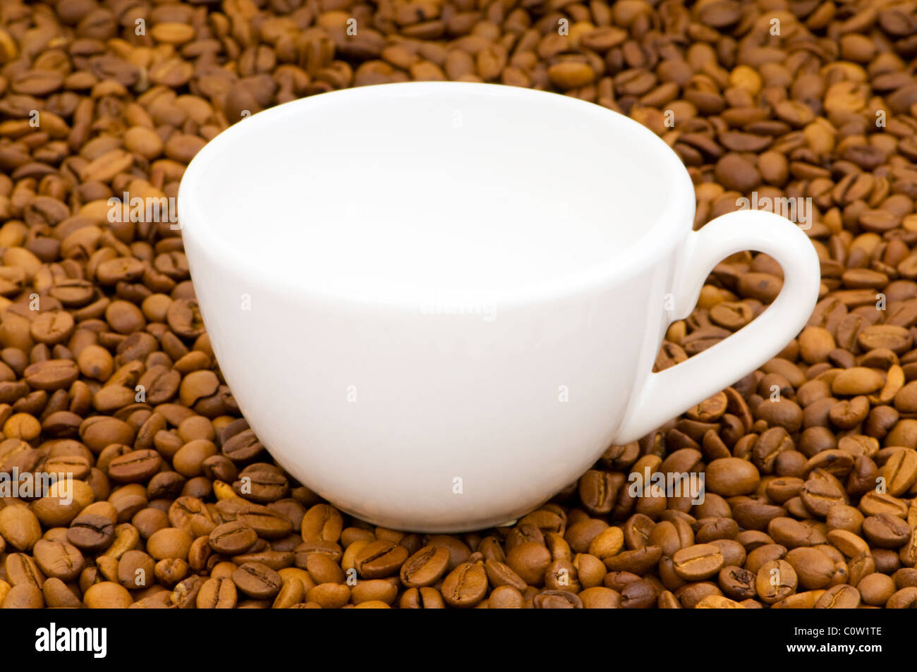 White cup and background of coffee beans Stock Photo - Alamy