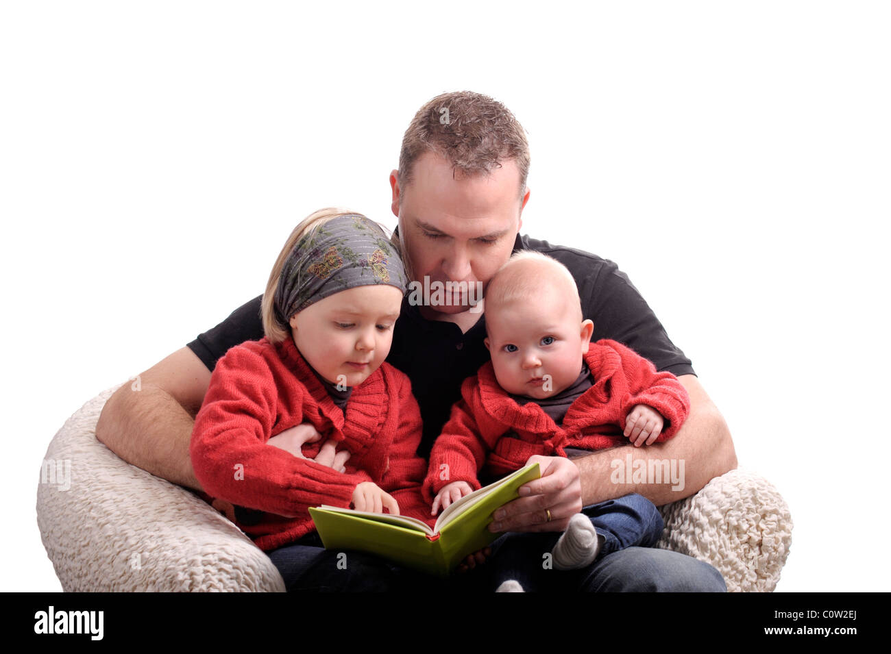 father reading a story at his two little daughters. isolated on white ...