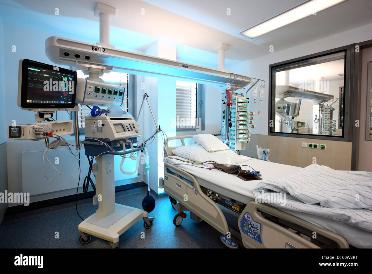 Intensive care unit in a hospital. A patient is connected to different ...