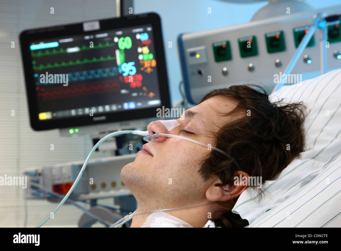Intensive care unit in a hospital. A patient is connected to different ...