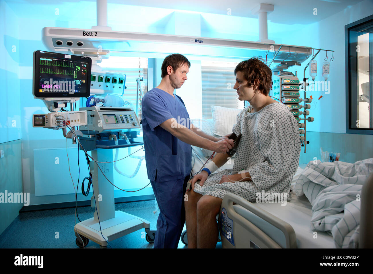 Intensive care unit in a hospital. A patient is connected to different ...