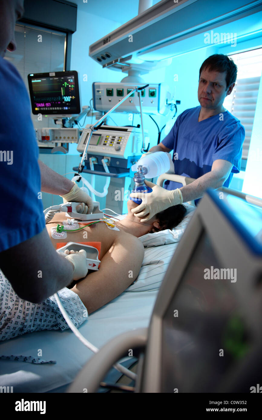 Intensive care unit in a hospital. A patient is connected to different ...
