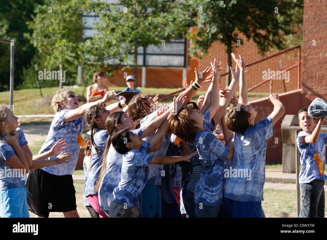 Fifth-grade boys play catch with water balloon during annual spring ...