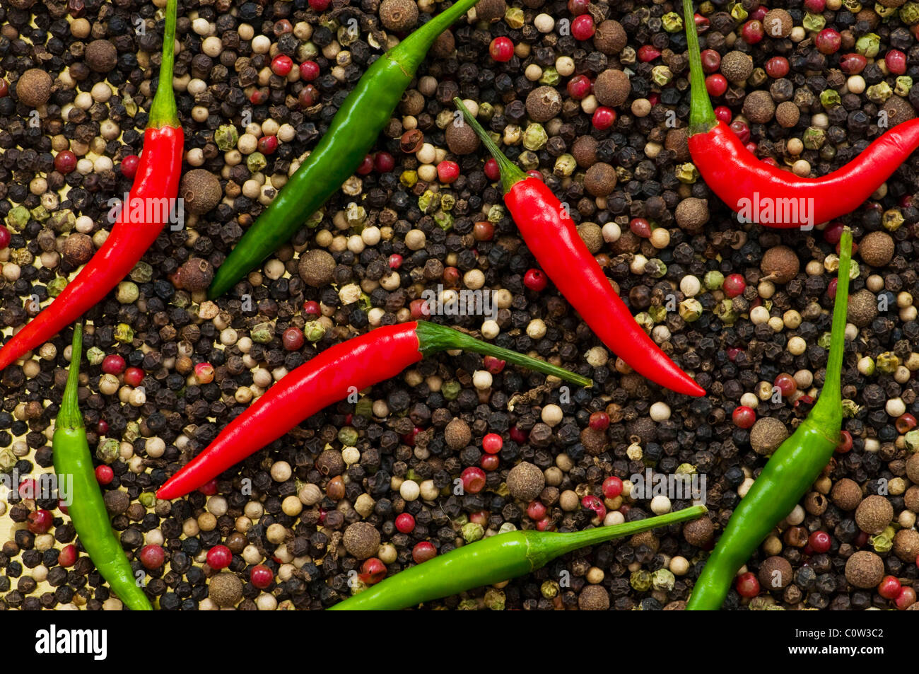 Red and green peppers on pepper background Stock Photo - Alamy