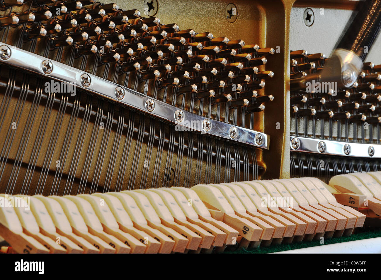Tuning the piano by adjusting the pegs Stock Photo - Alamy