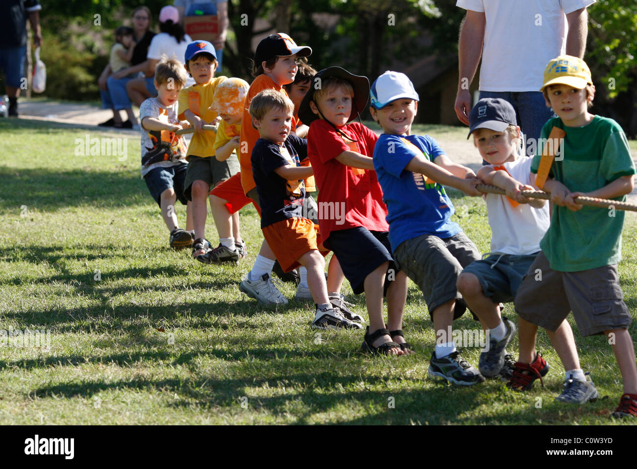 Second-grade boys and girls pull on rope during tug-of-war at ...