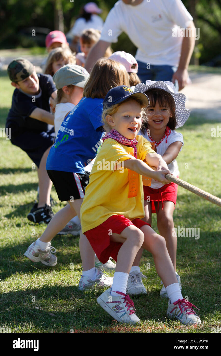 Second-grade boys and girls pull on rope during tug-of-war at ...