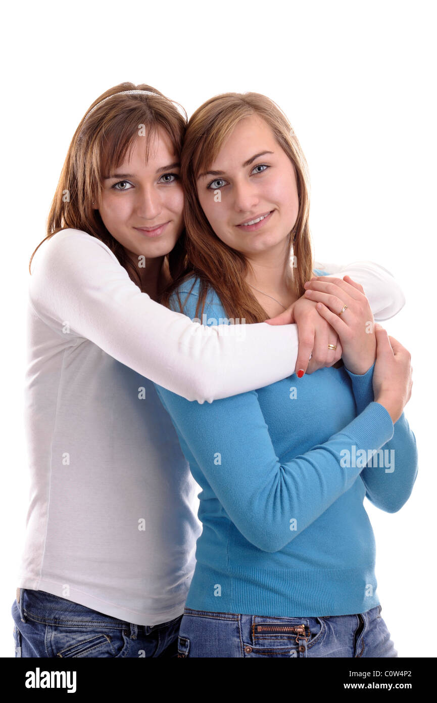 two young women hugging each other. Isolated on white Stock Photo - Alamy