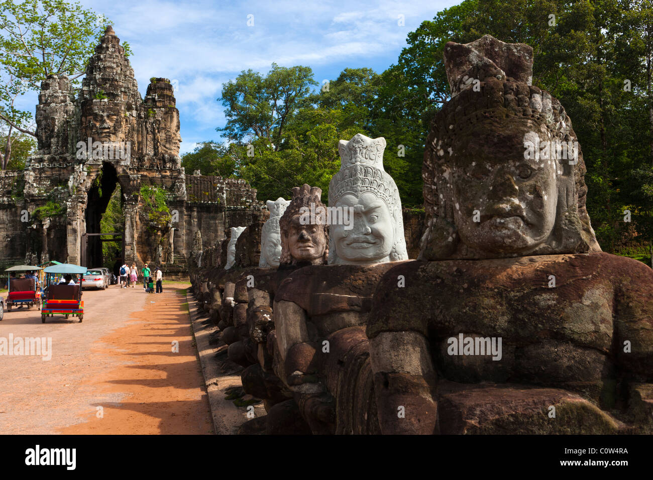 South Gate. Stone sculptures border the bridge to the temple Angkor ...