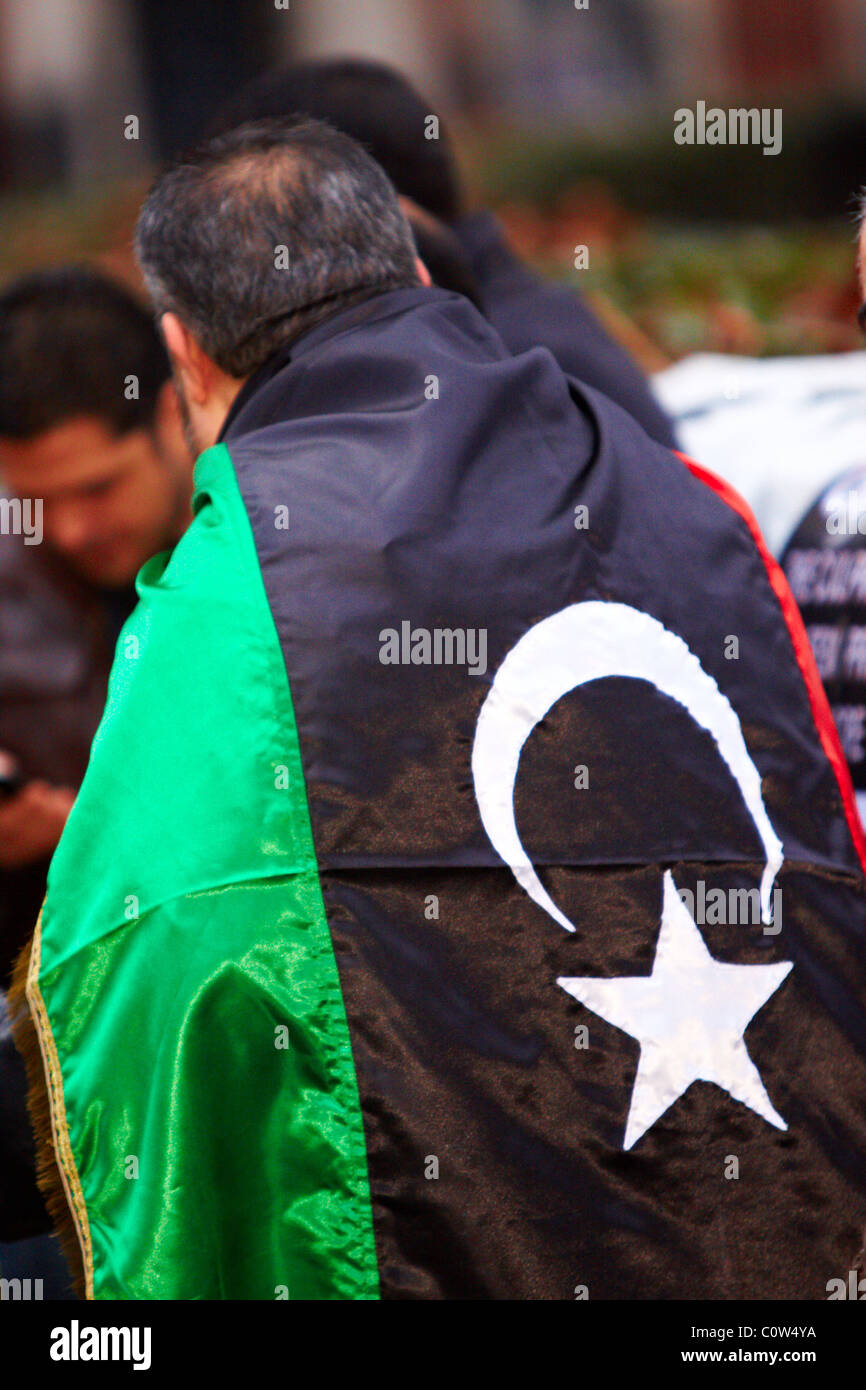 LONDON, UK. Man draped in the traditional Libyan flag now called the ...