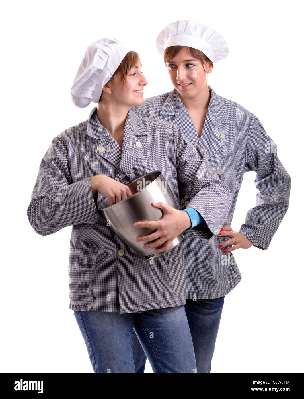 two young apprentice cooks on white background Stock Photo - Alamy