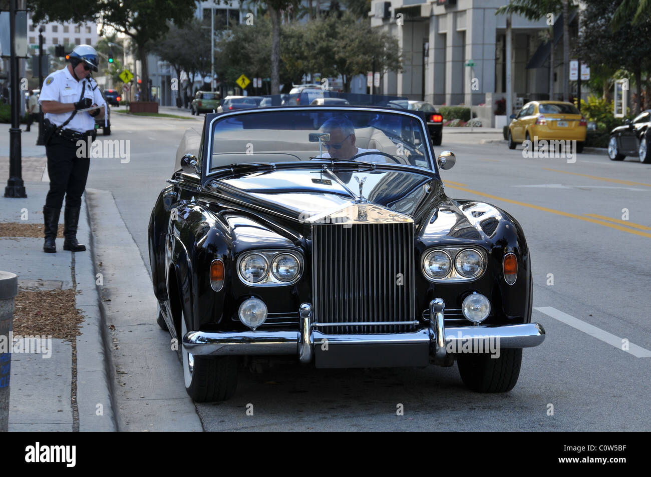 Rolls Royce driver getting parking ticket Stock Photo - Alamy