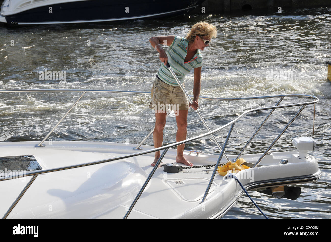 Lady mopping yacht's deck Stock Photo - Alamy