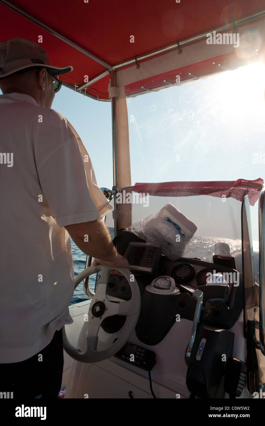 Man driving boat yacht "mid section" close Stock Photo - Alamy