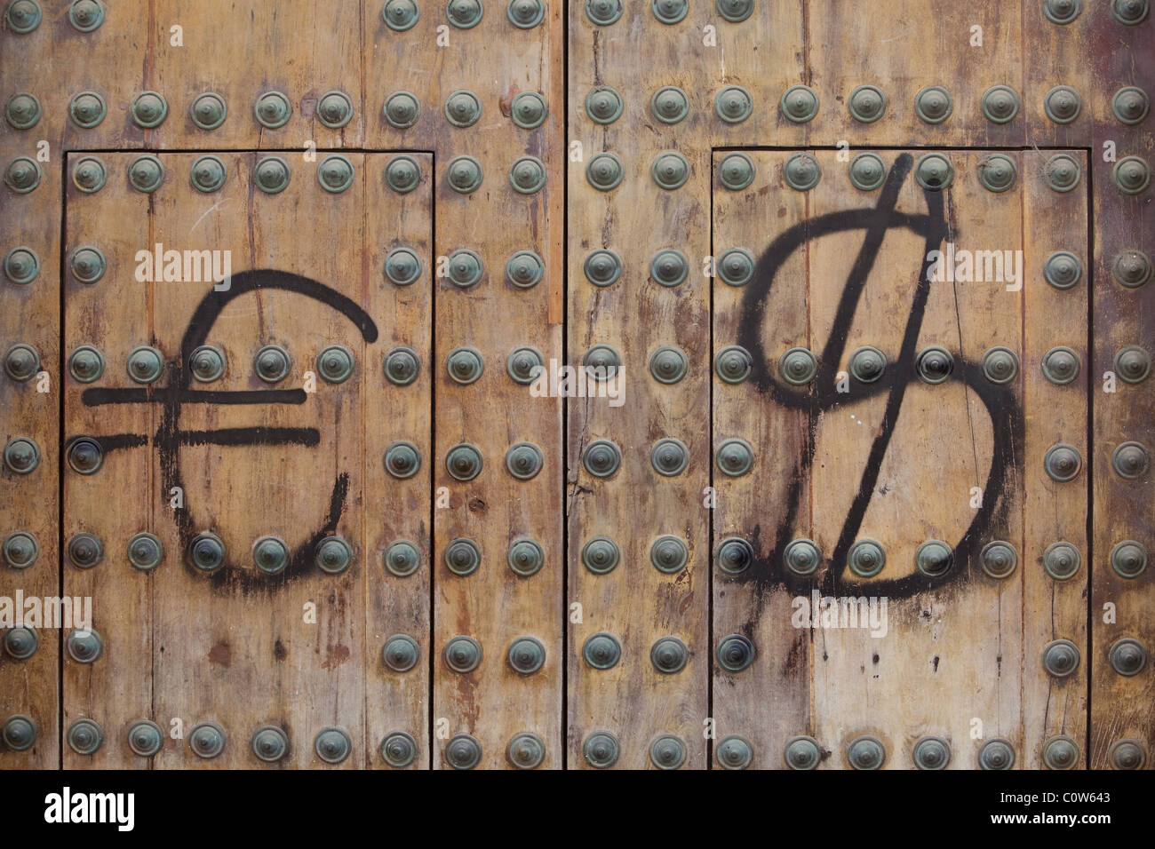 Cadiz graffiti on church doors with euro and dollars sign. Spain Stock ...