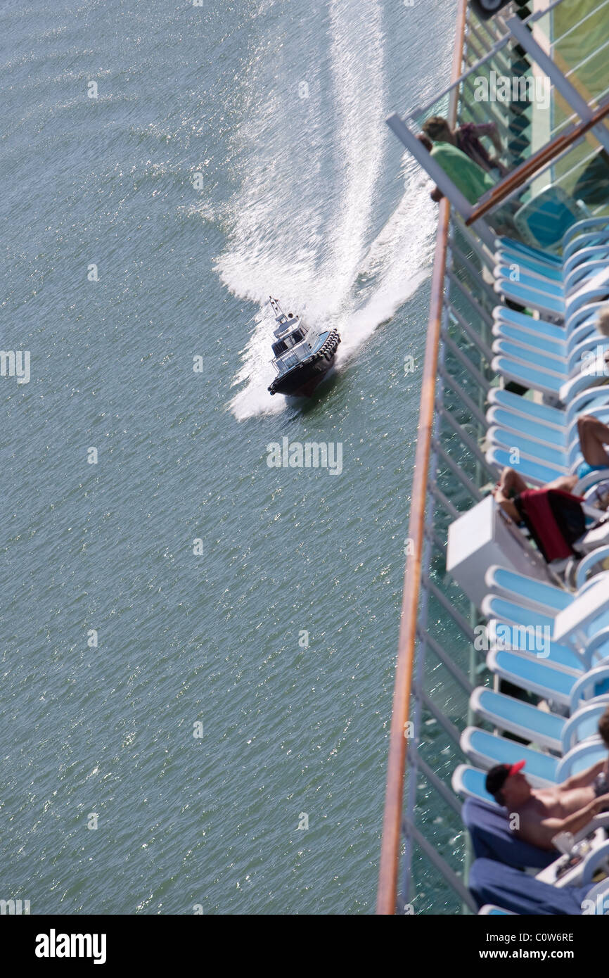 Pilot launch at high speed passing passenger ship en route to another ...