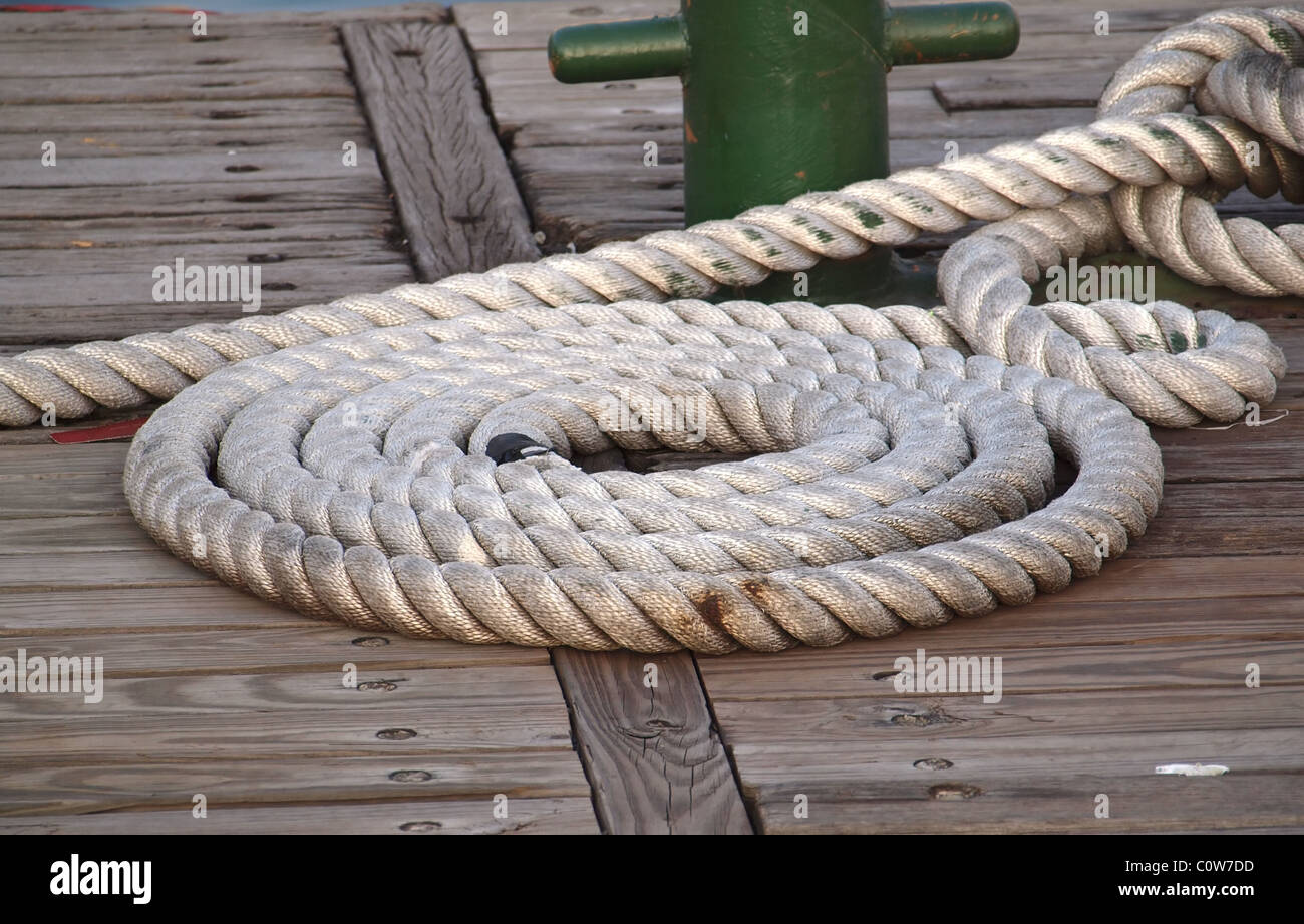 A think rope for tying ships is rolled up in coil Stock Photo - Alamy