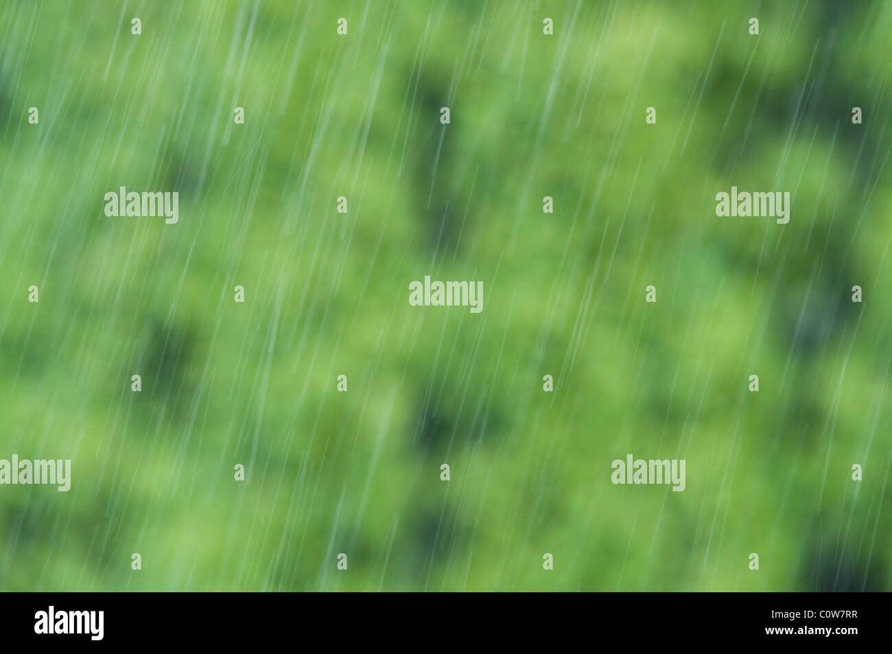 raindrops falling down on green blurry background Stock Photo - Alamy