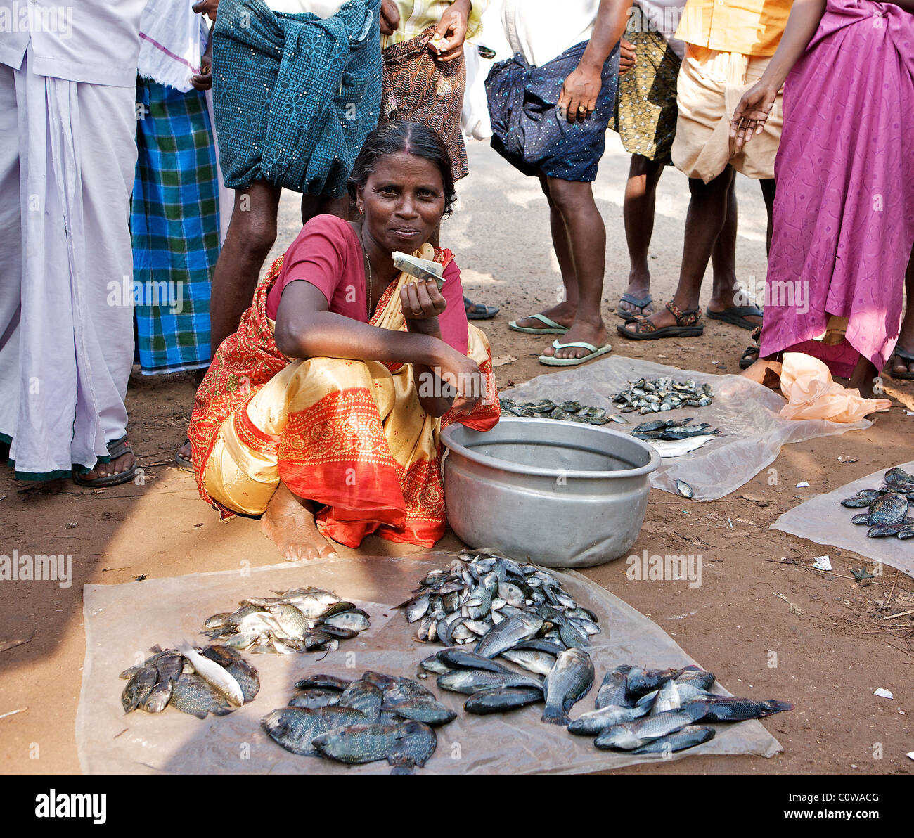 Keralite women wait to sell their fish at a roadside fish market in the ...