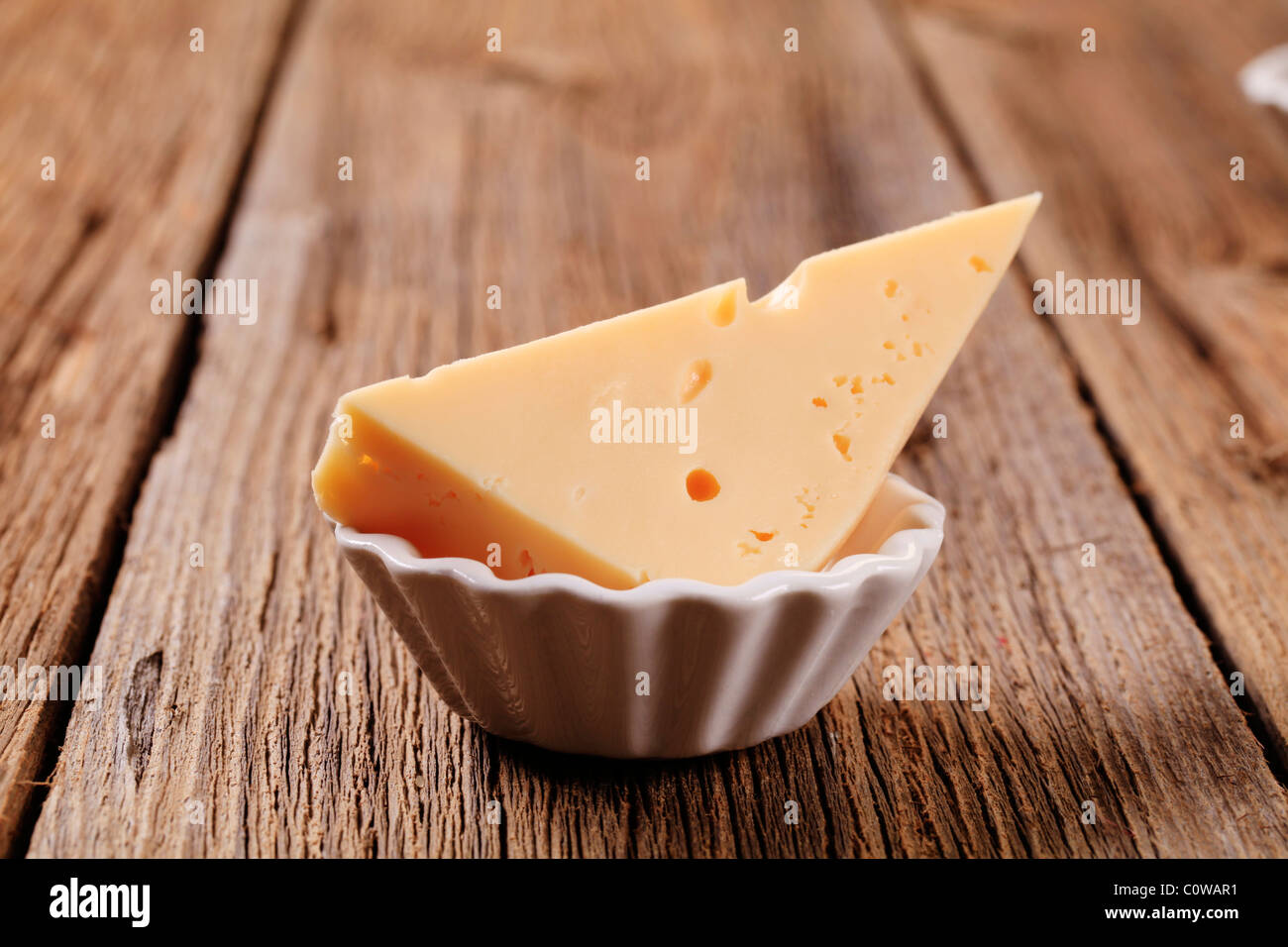 Piece of edam cheese in a small bowl Stock Photo - Alamy