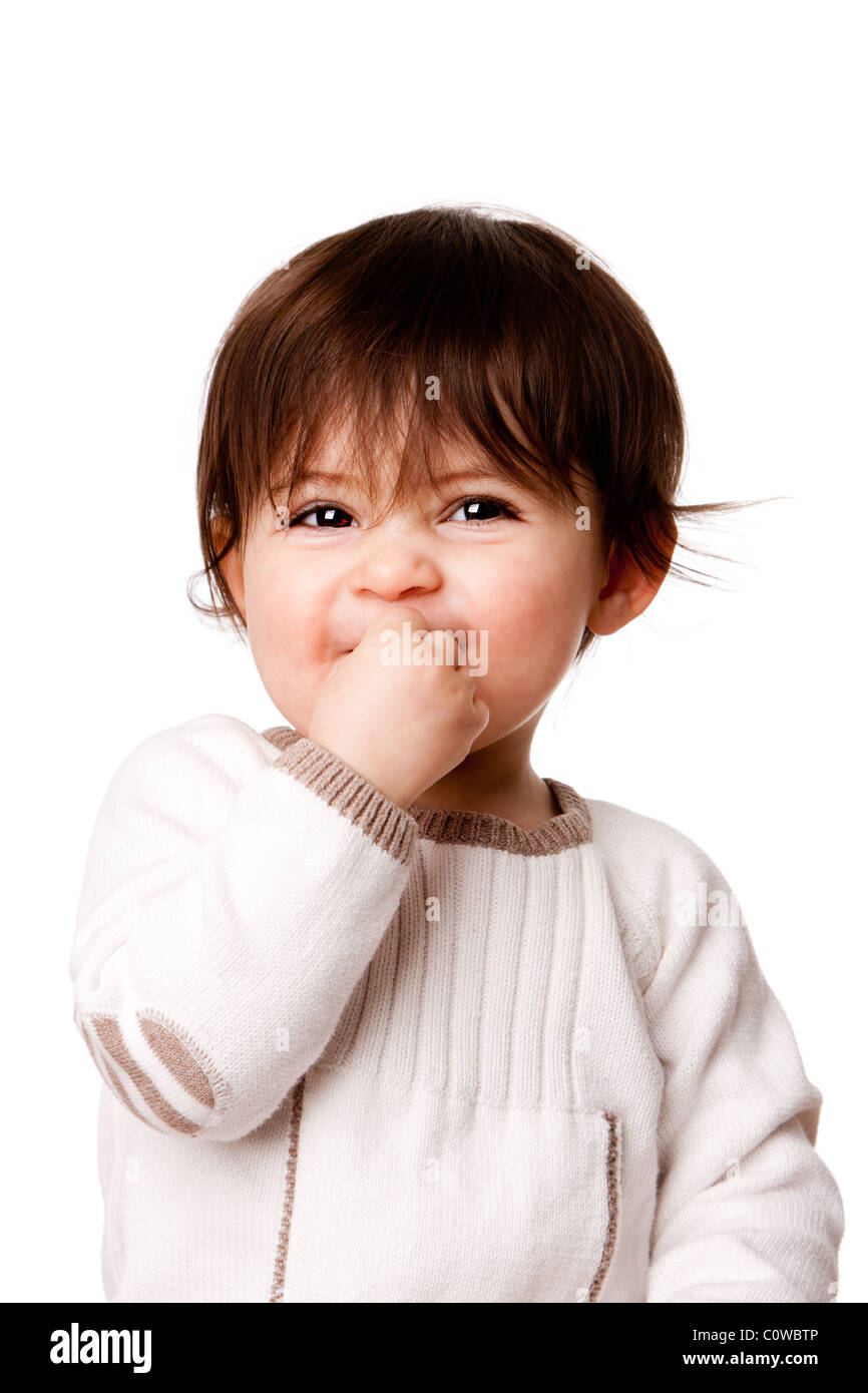 Face of a cute adorable baby infant toddler with innocent mischievous naughty expression ...