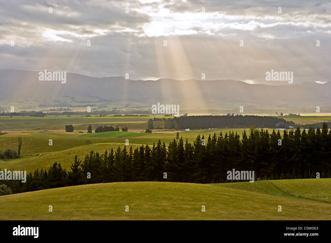 sunshine through the clouds in New Zealand Stock Photo - Alamy