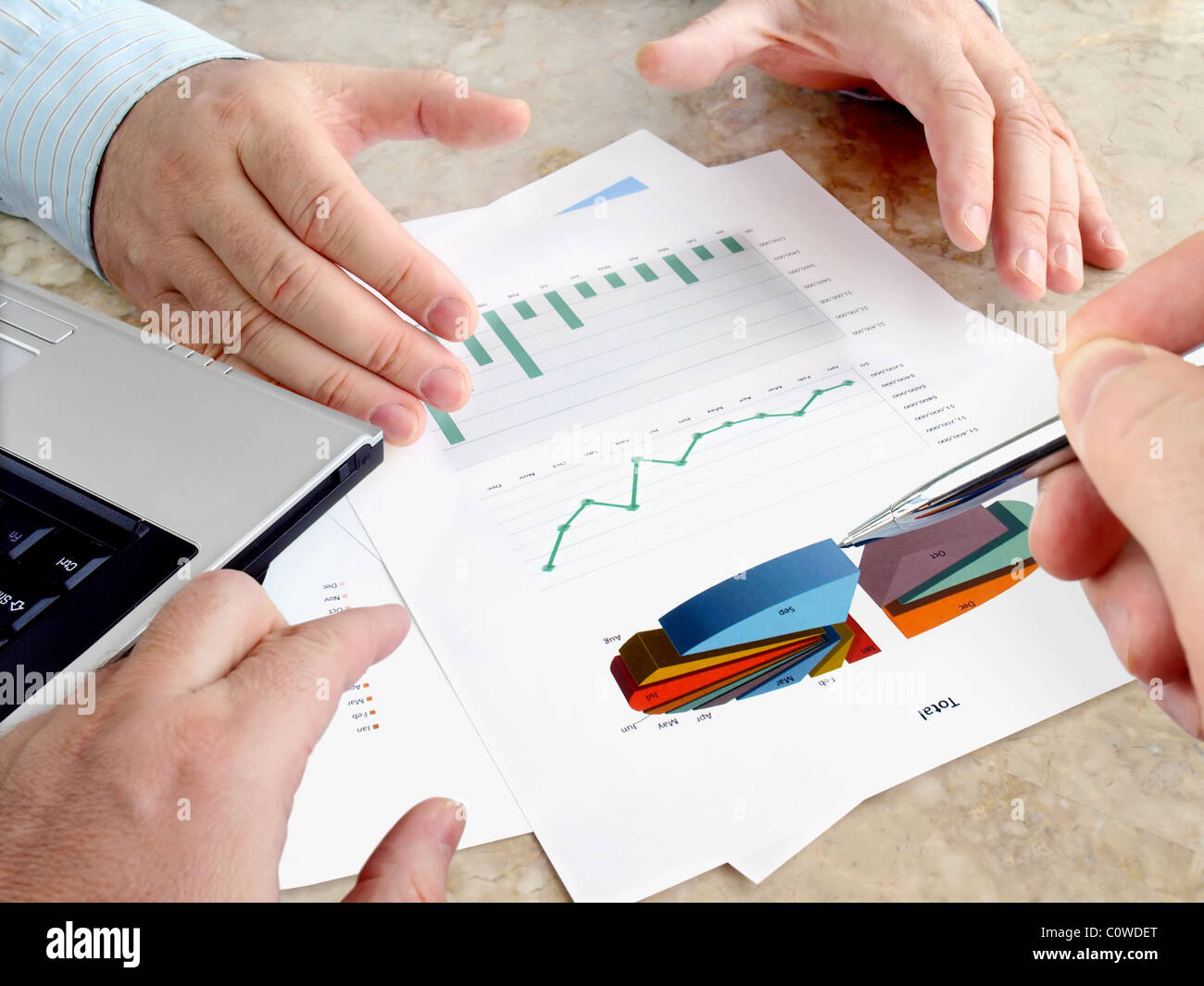 Closeup of hands with financial charts at business meeting in the ...