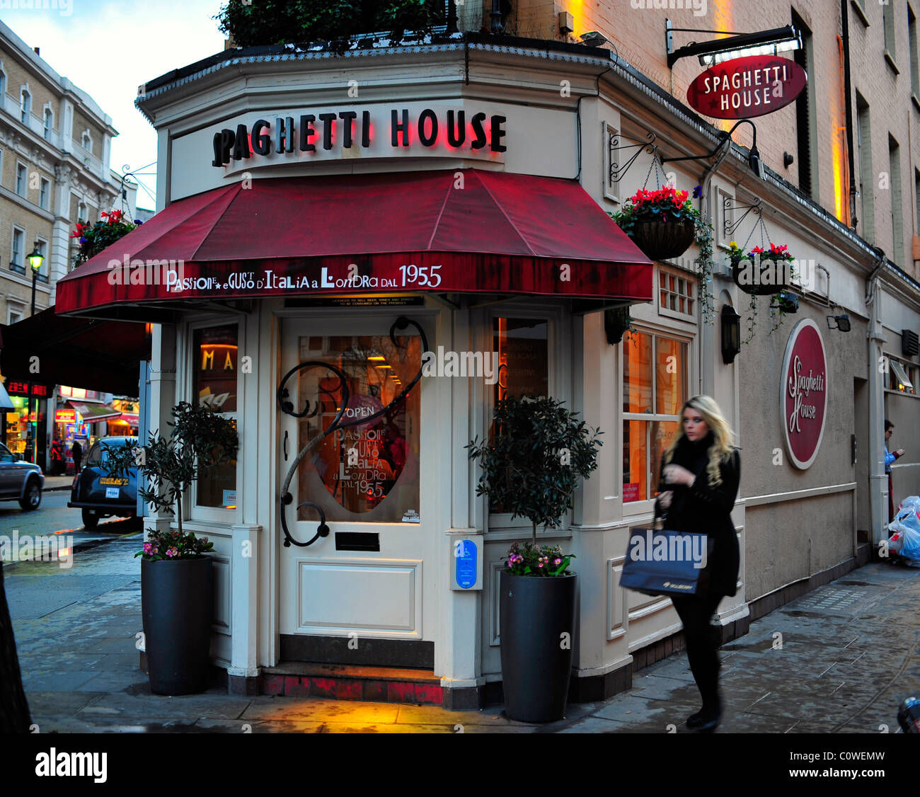 Spaghetti House on a street corner in London with woman walking past ...