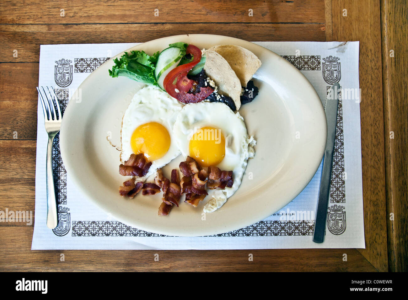 American breakfast of bacon & eggs with Mexican garnish of frijoles ...