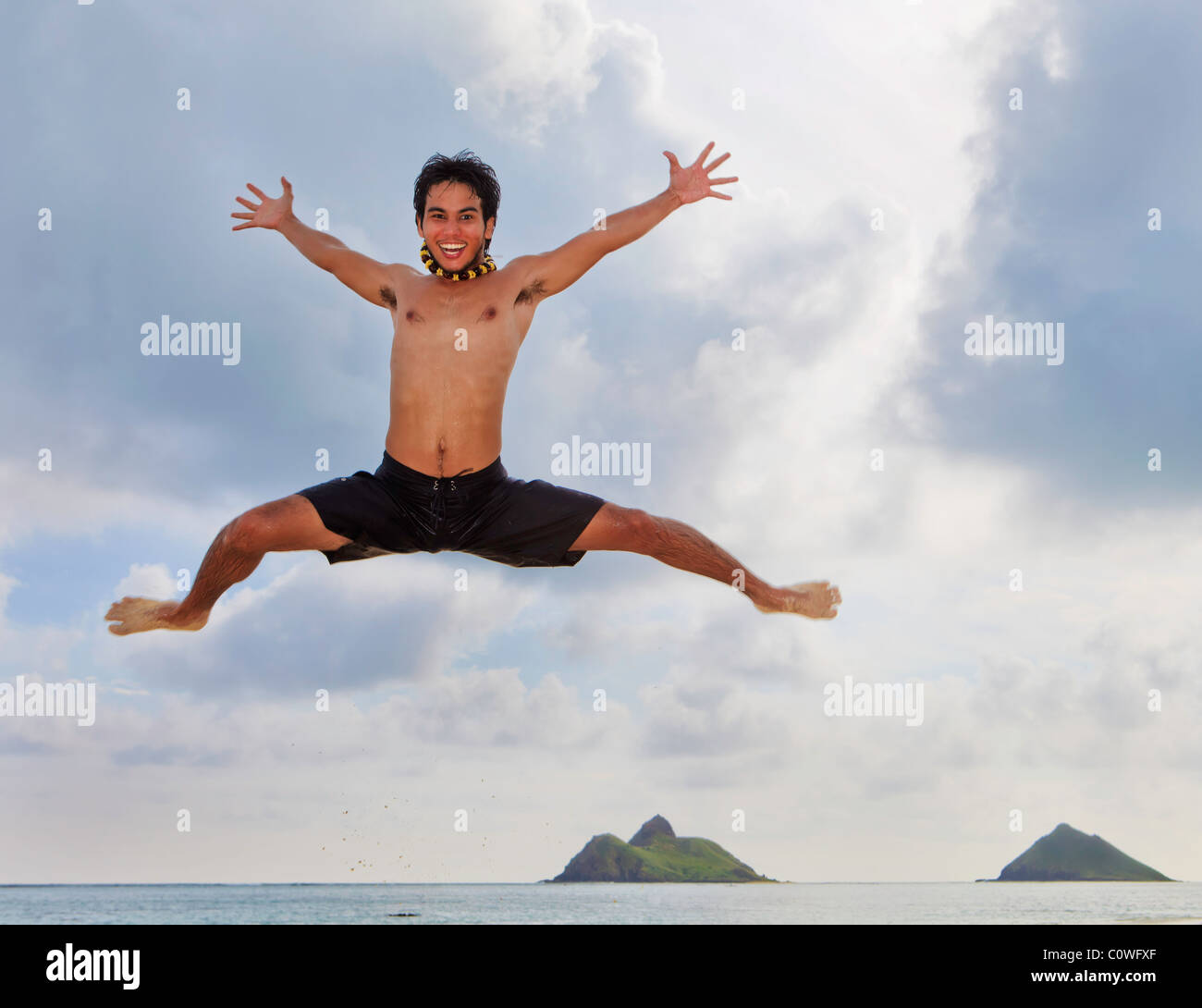 asian man jumping at the beach in hawaii Stock Photo - Alamy