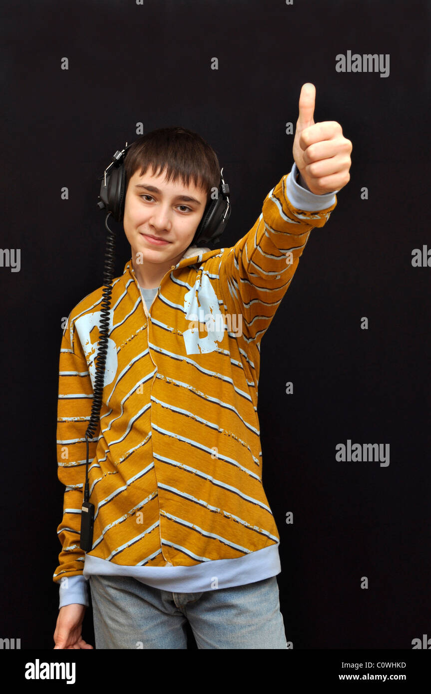 Young DJ with headphones in a yellow t-shirt on a black background ...