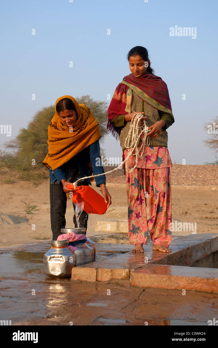 2 two girls getting water from village well in Rajasthani desert Stock ...