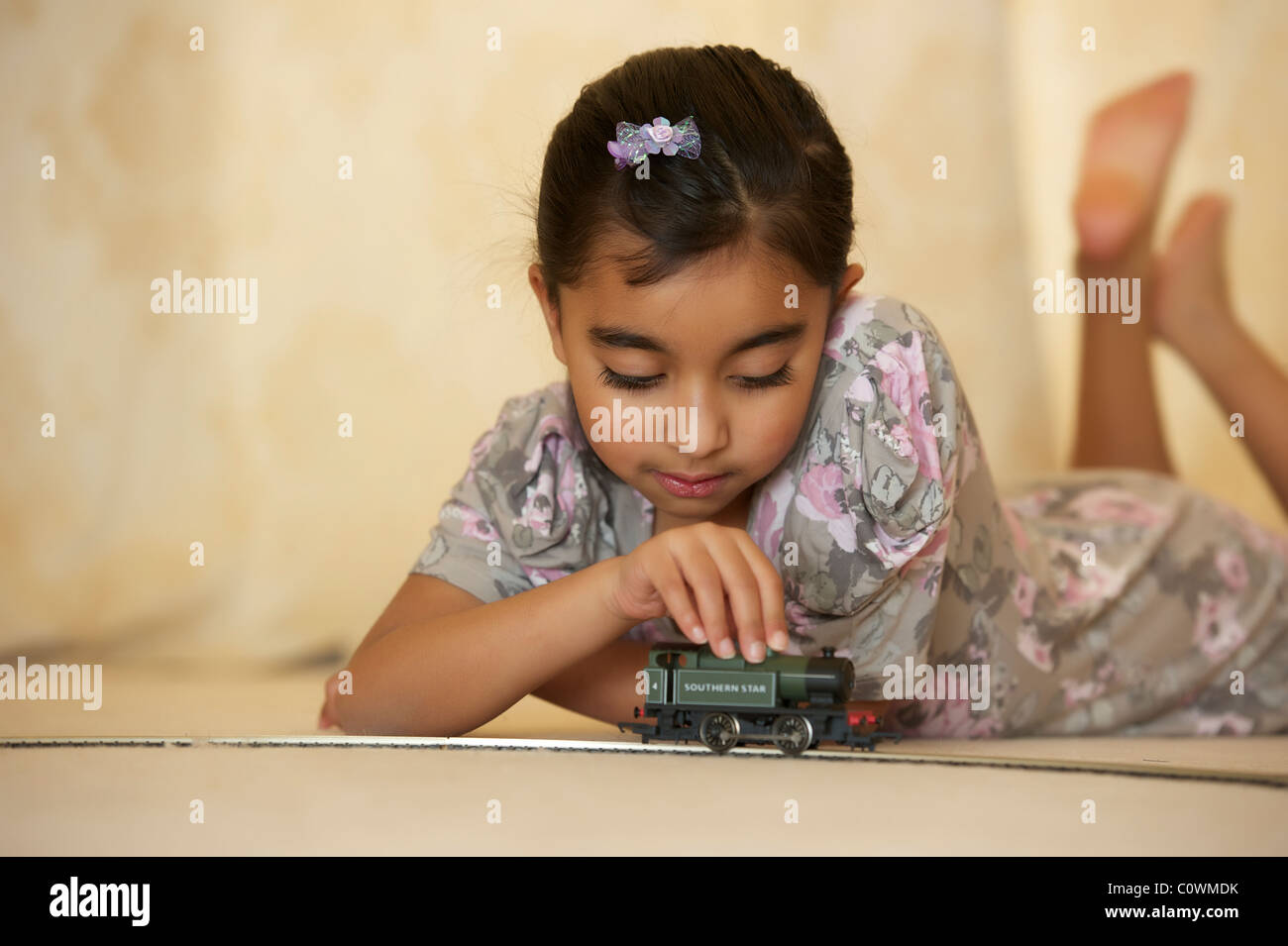 A young girl playing with her toy train set Stock Photo - Alamy