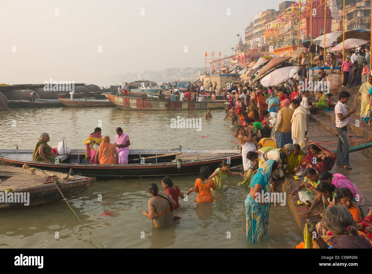 Pilgrims bathing in the River Ganges at Man Mandir Ghat, Varanasi ...