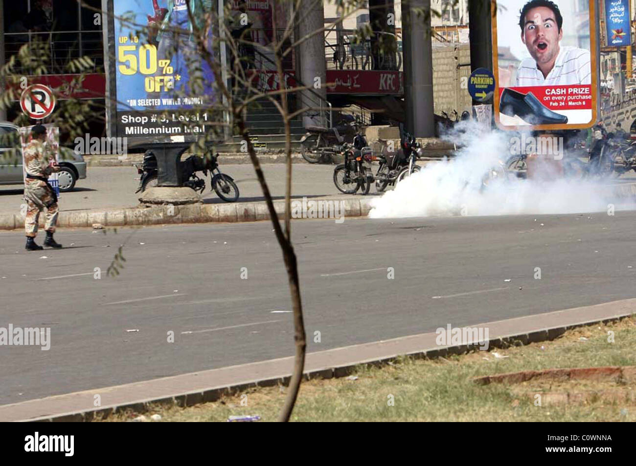 Smoke rises from a tear-gas shell which was fired by policemen to ...