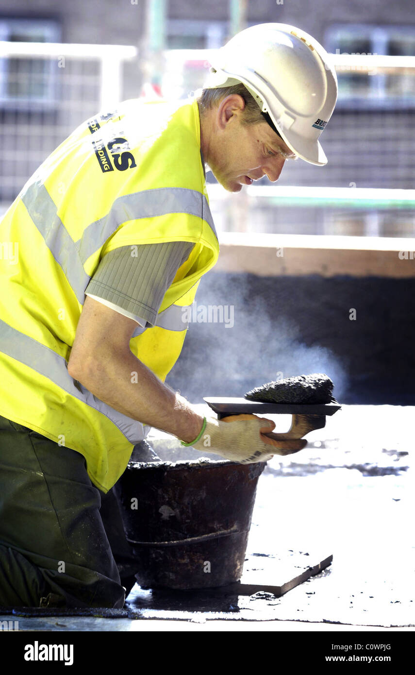 Construction workers working on office building roof, Edinburgh ...