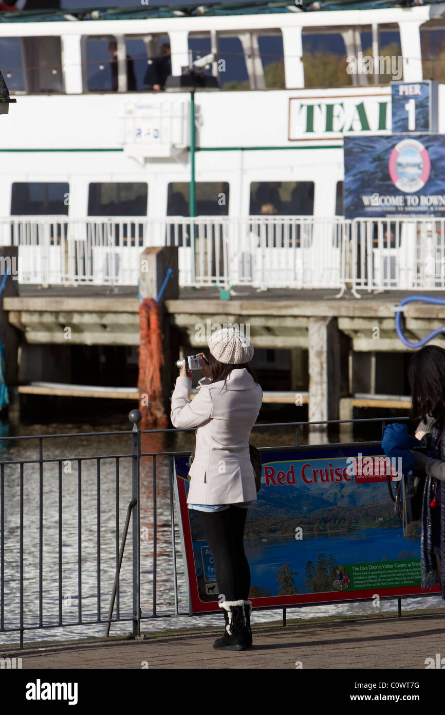 female tourist taking photograph with the steamer Teal in the ...
